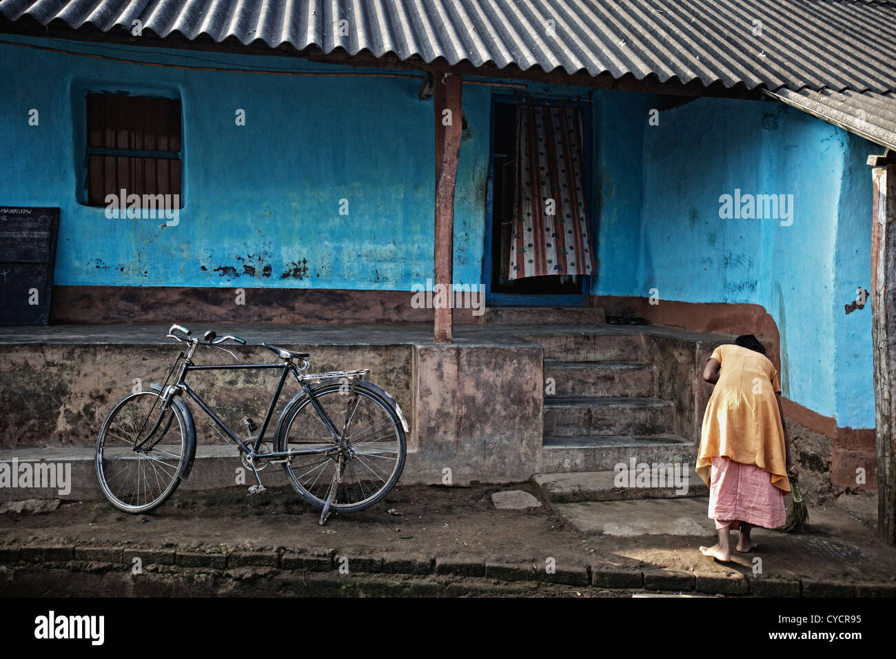 Indian woman sweeping outside her house Stock Photo - Alamy