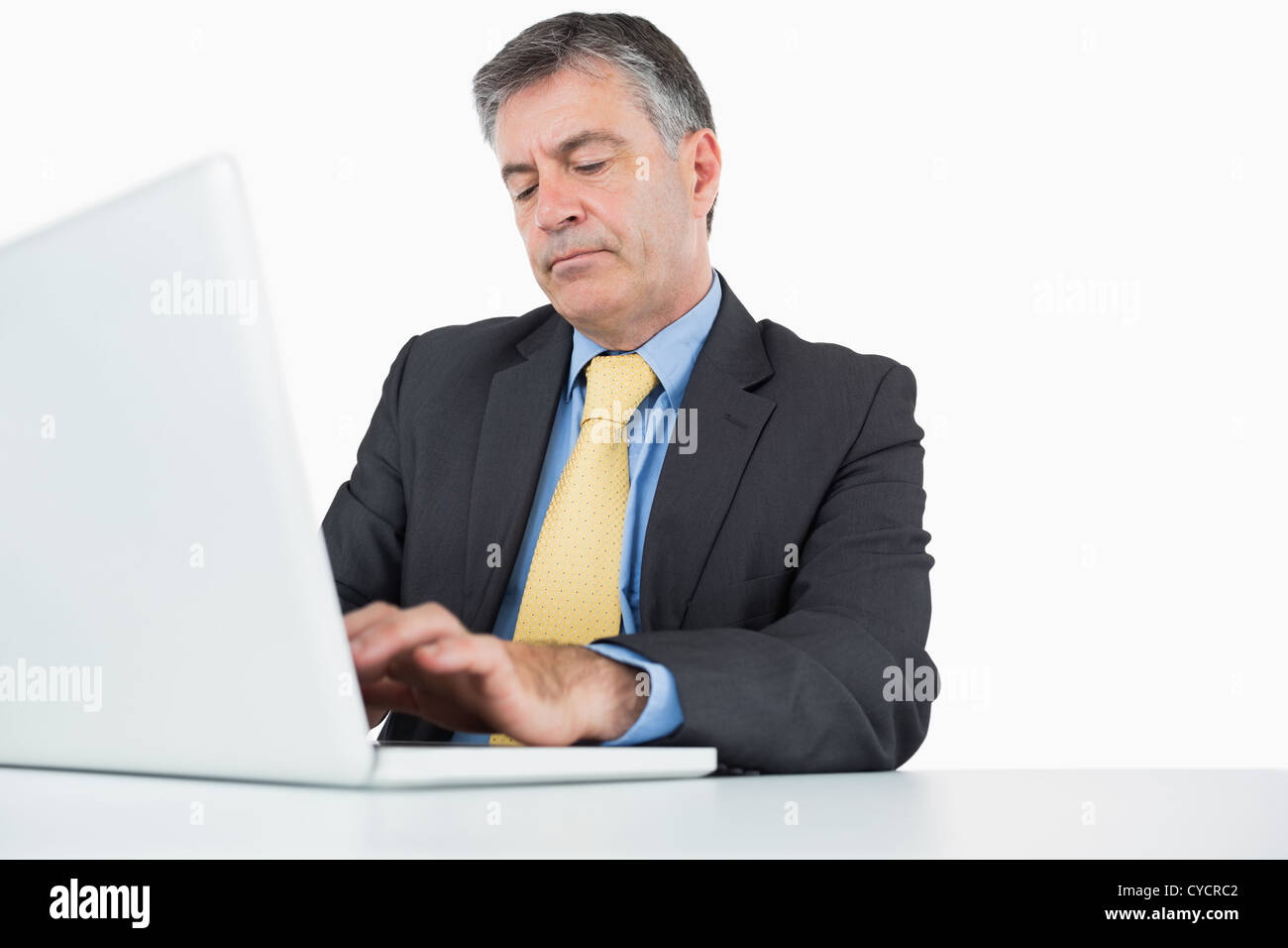 Concentrated man typing on his laptop Stock Photo - Alamy