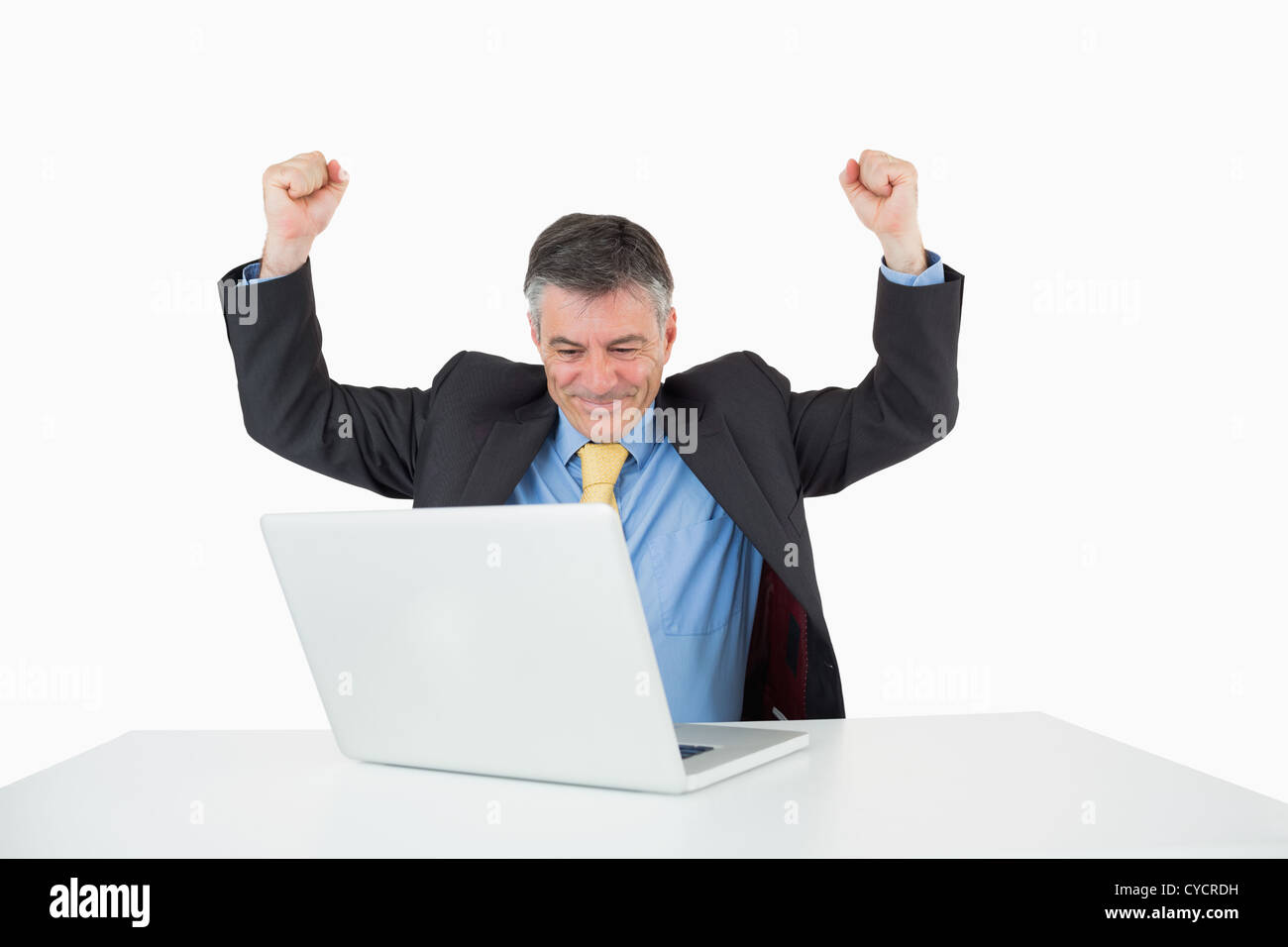 Man being victorious at his desk Stock Photo - Alamy