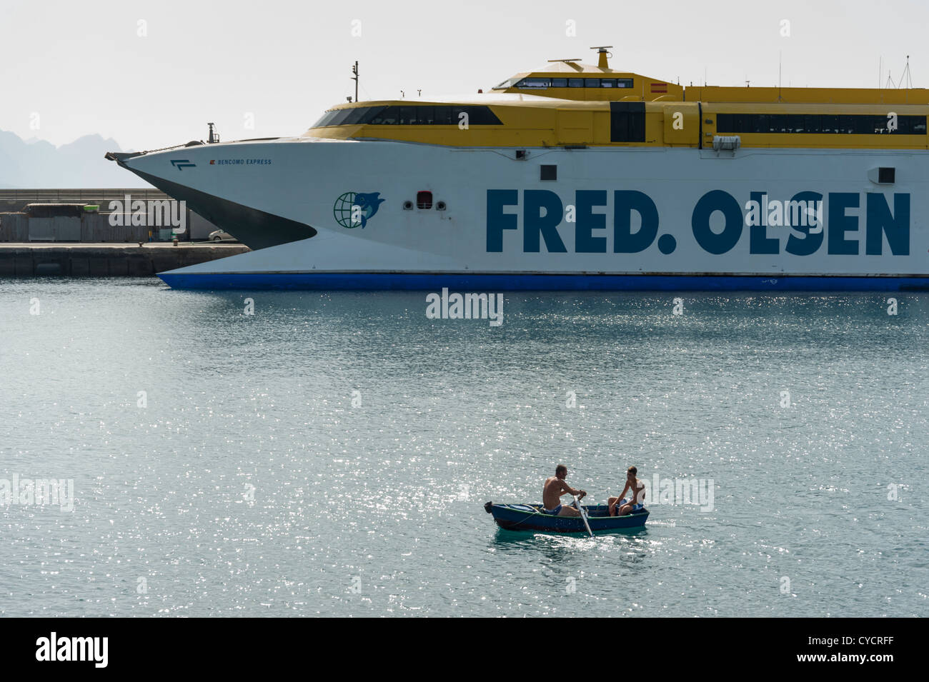 Fred Olsen hydrofoil ferry with men in small rowing boat in front at ...