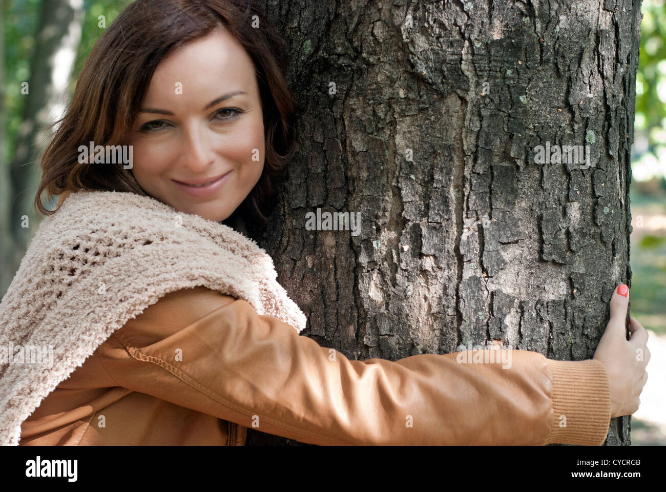 Pretty woman hugging a big tree in a park - outdoor portrait Stock ...