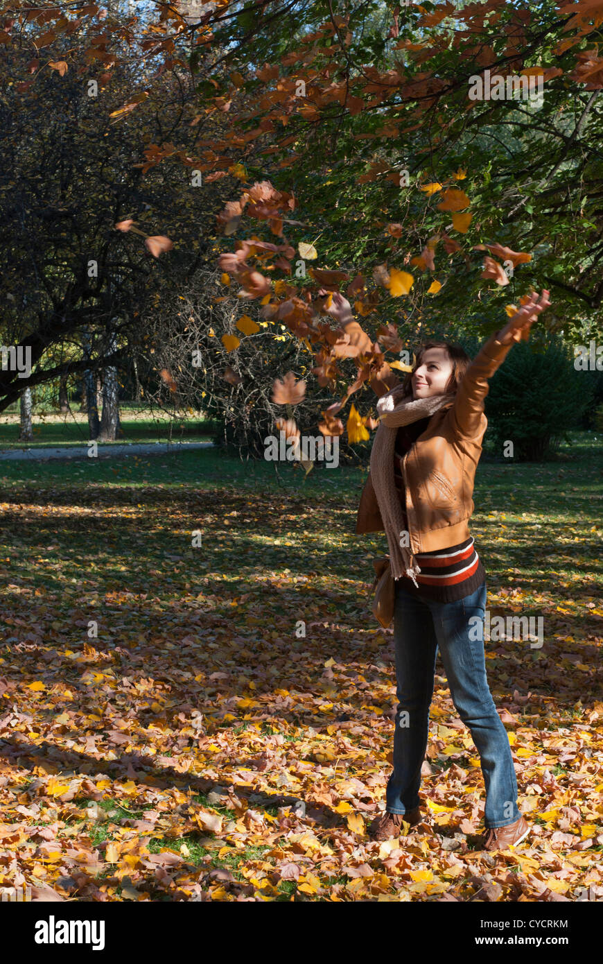 Woman throwing leaves in fall, happy day Stock Photo - Alamy