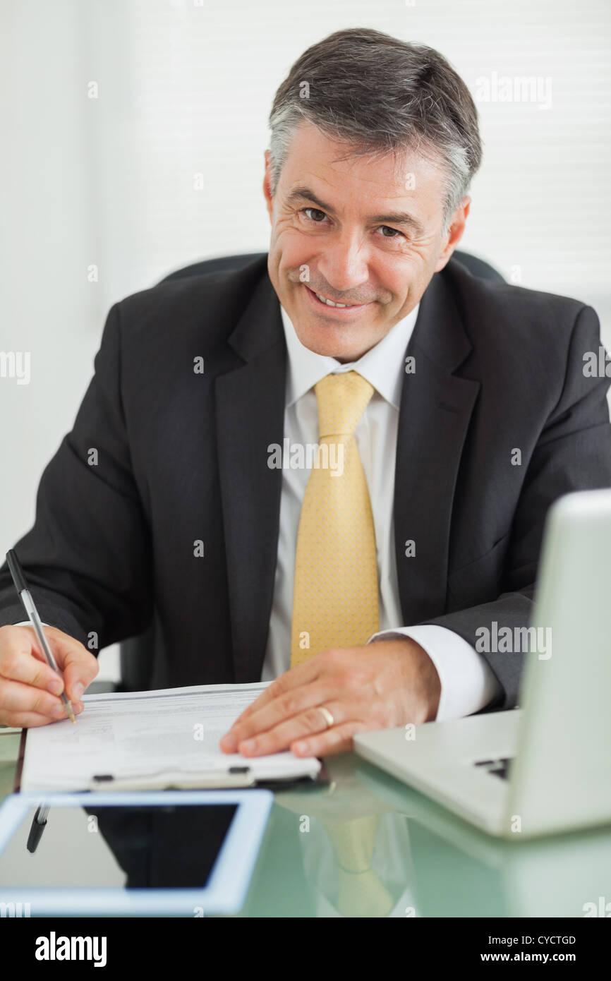 Business man smiling while working Stock Photo - Alamy