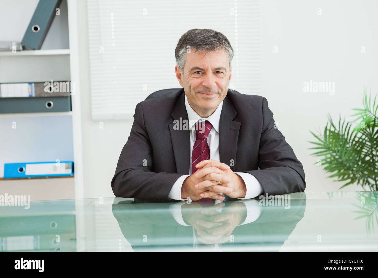 Man smiling in his office Stock Photo - Alamy