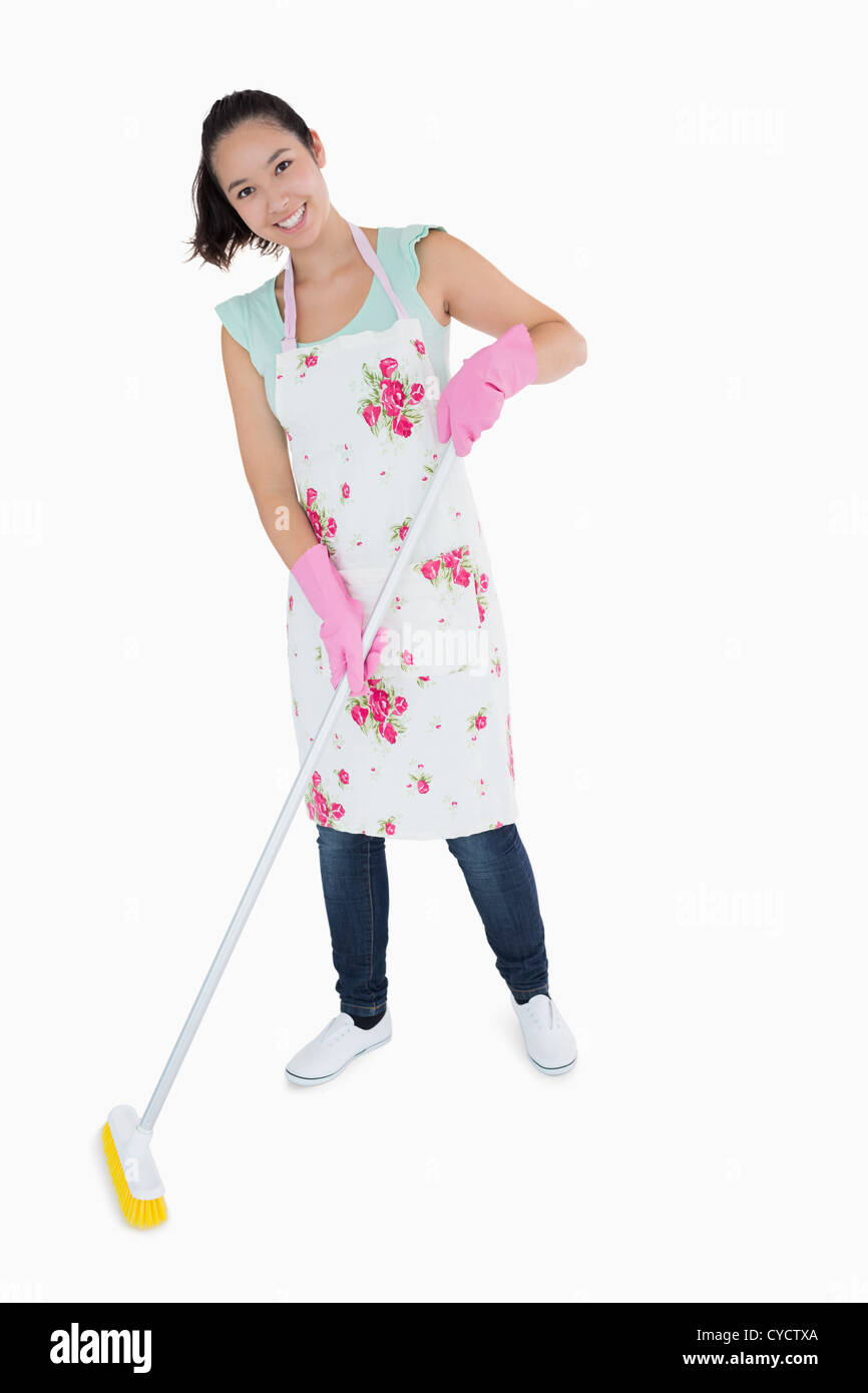 Happy woman sweeping floor Stock Photo - Alamy