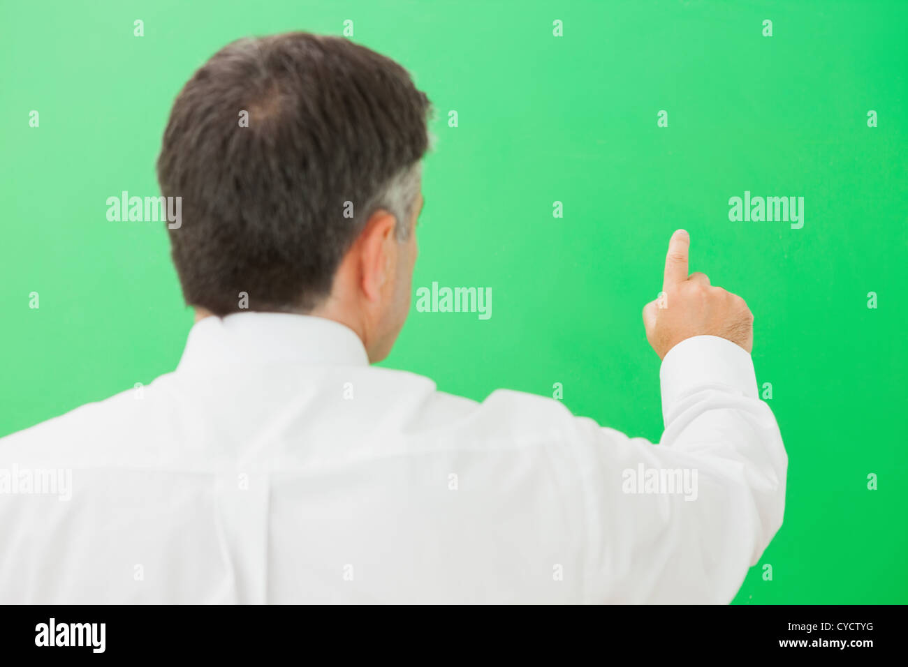 Man pointing on a green screen Stock Photo - Alamy
