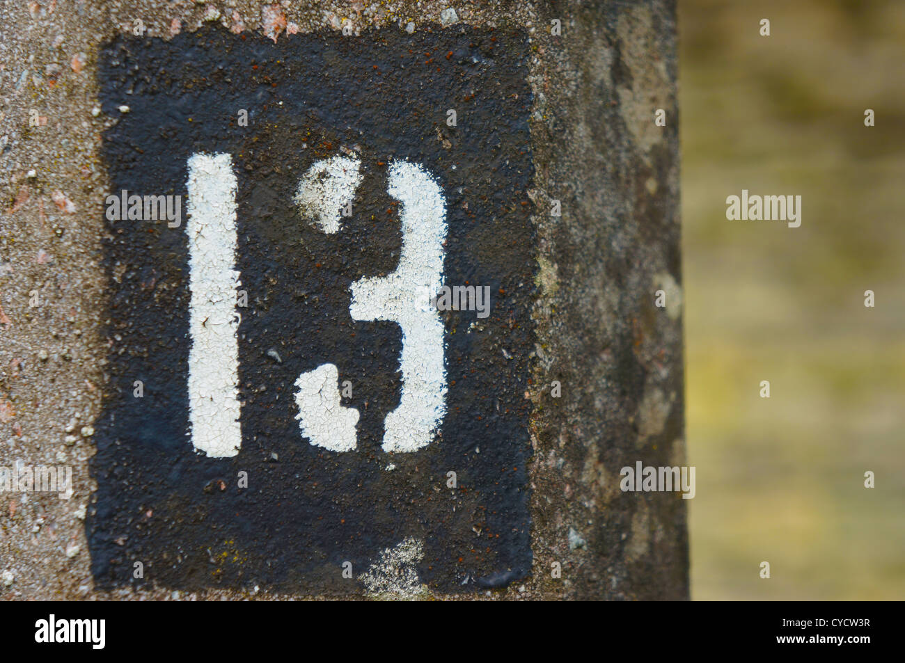 The number 13 (thirteen) stencilled onto a concrete lamp post Stock ...