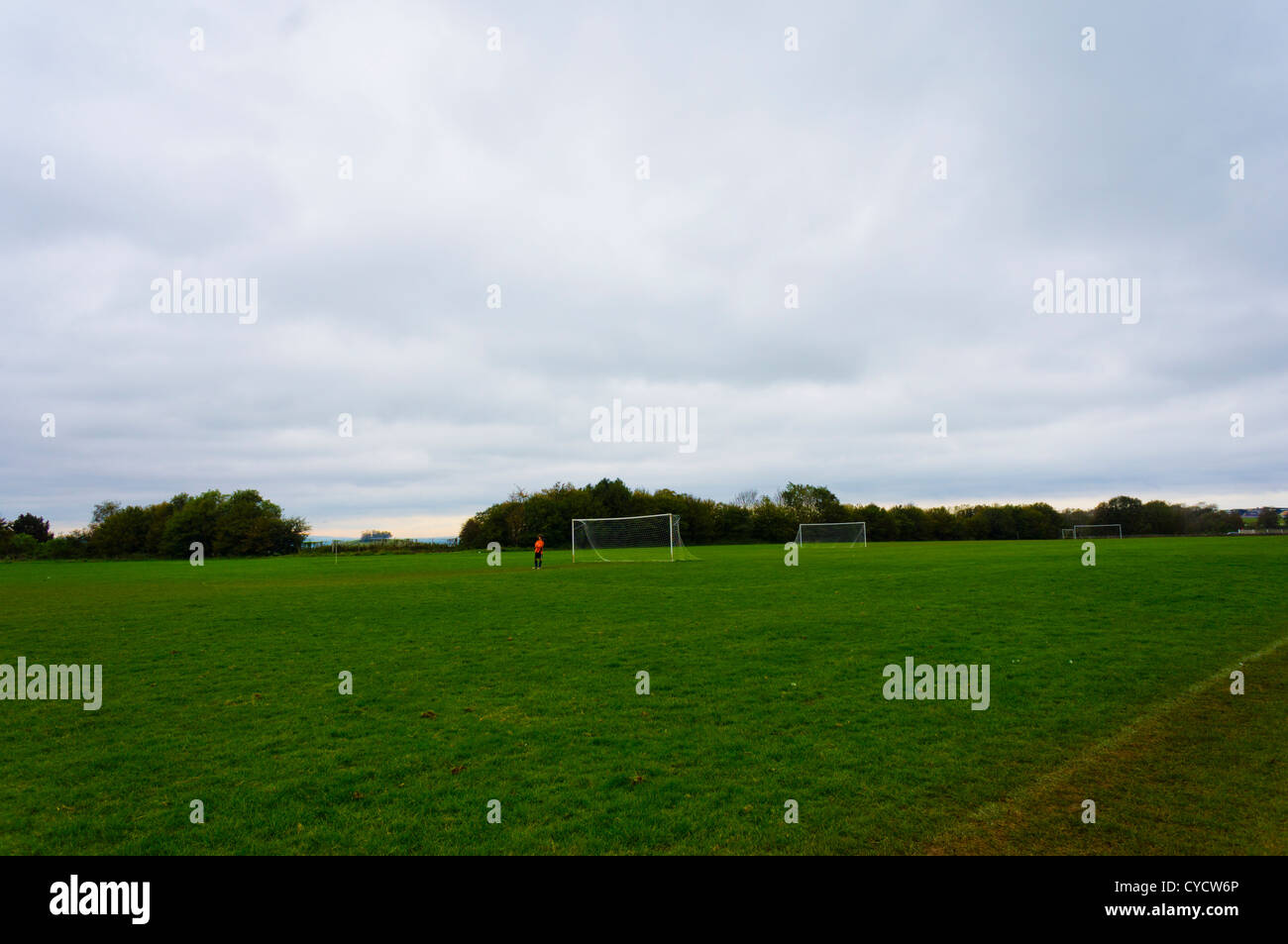 A lonely football goalkeeper stands waiting to be involved in a game of ...