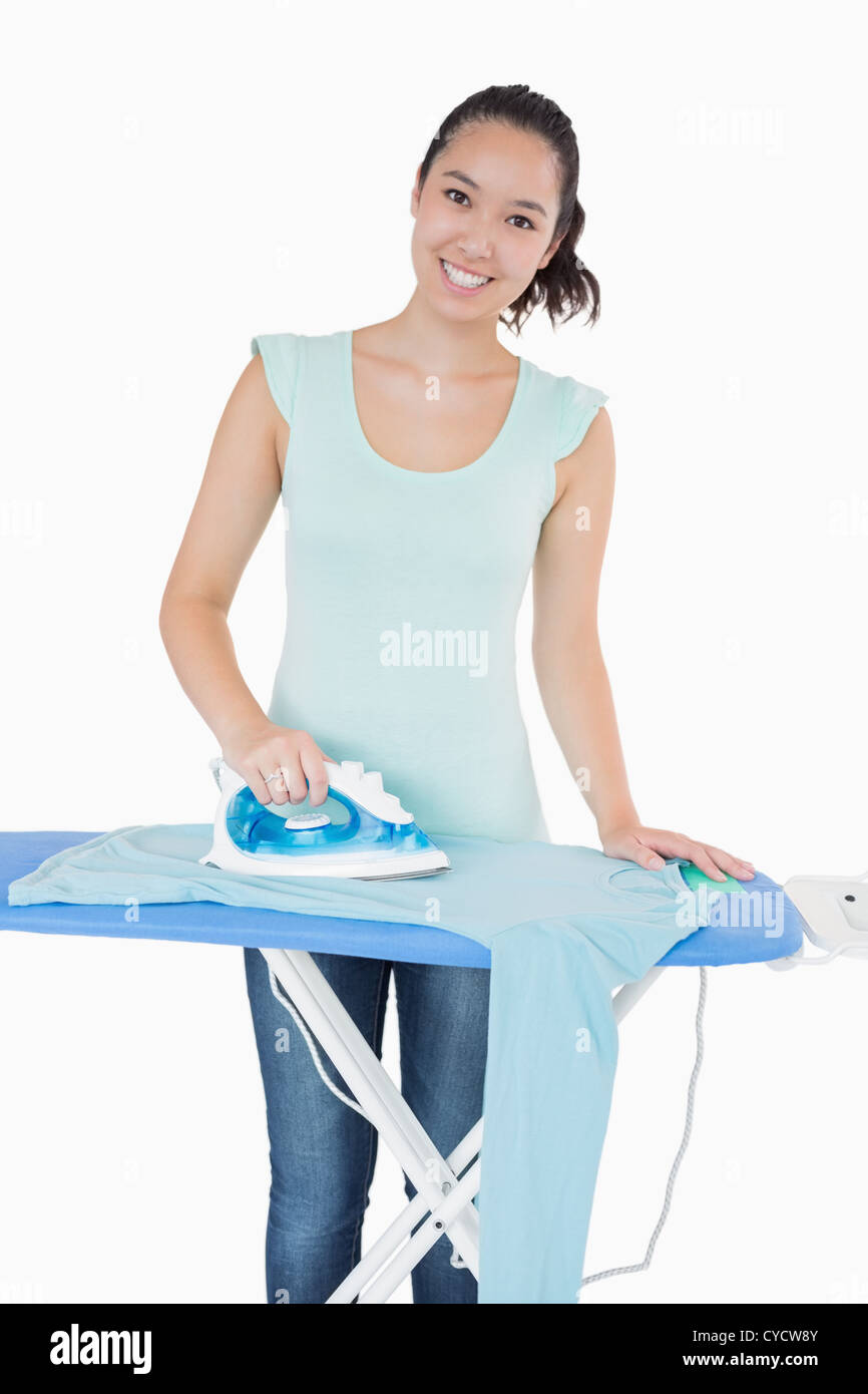 Woman happily doing the ironing Stock Photo - Alamy