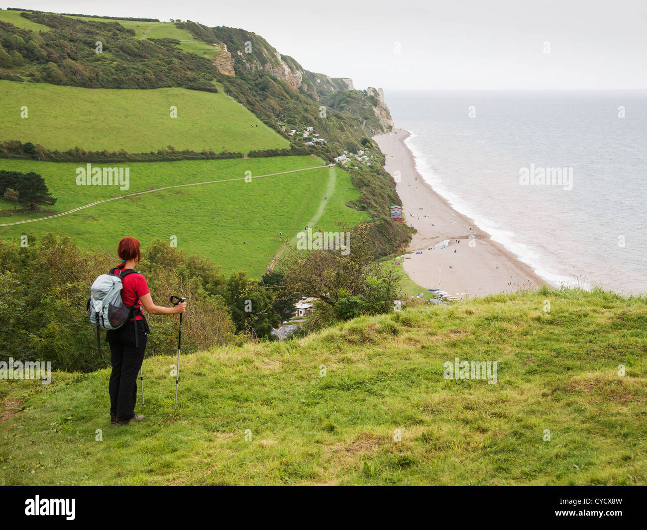 A female walker looking out over the beach at Branscombe Bay in South ...