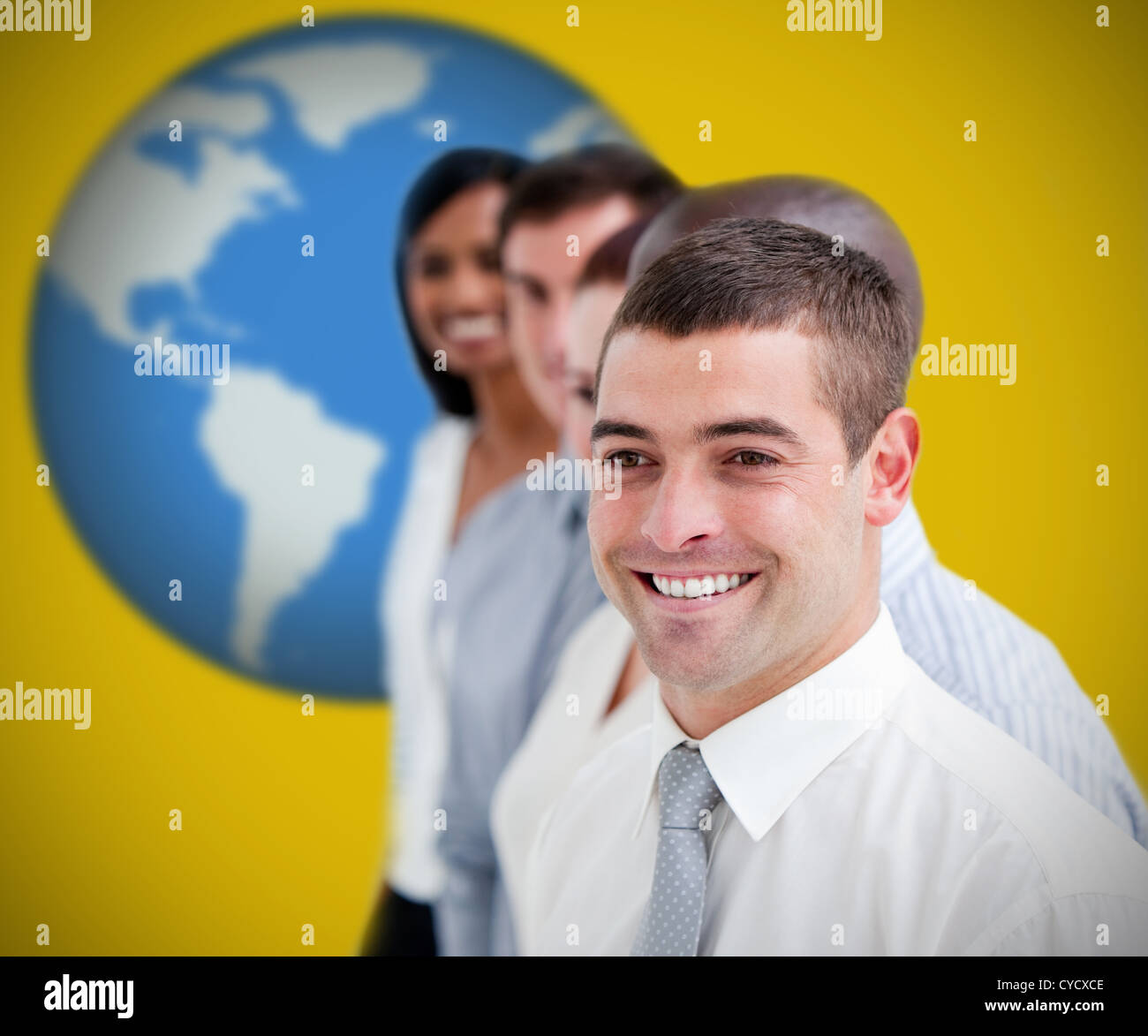 Businesspeople standing and smiling against yellow background Stock ...