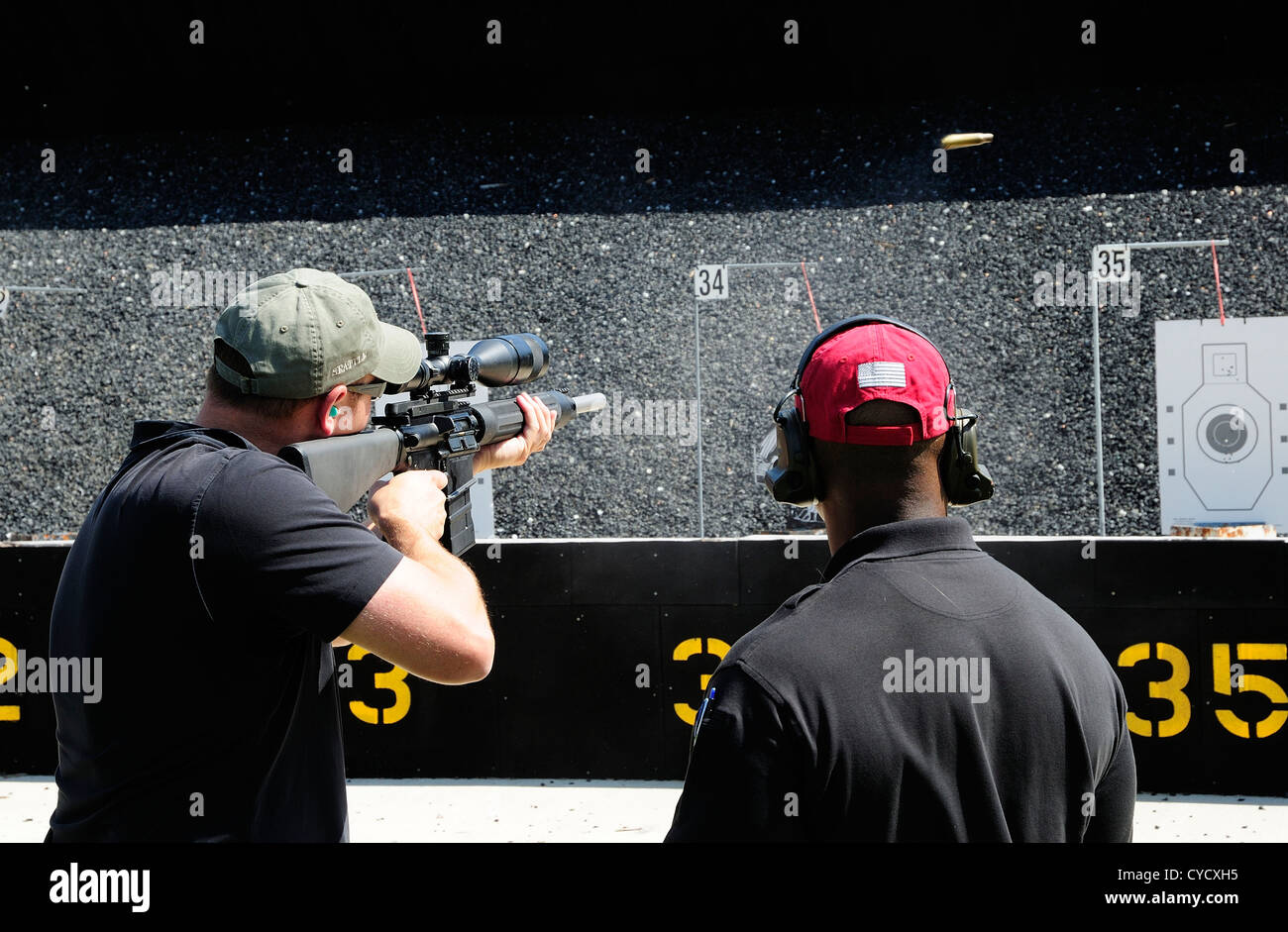 Gunman test firing automatic rifle at the FBI shooting range in Chicago ...