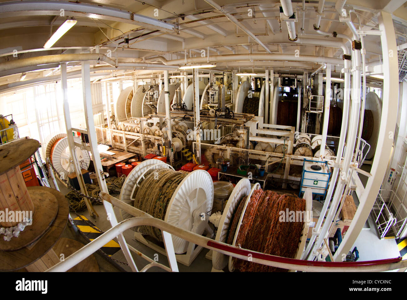 Seismic cables spooled in big reels on streamers deck of seismic vessel ...