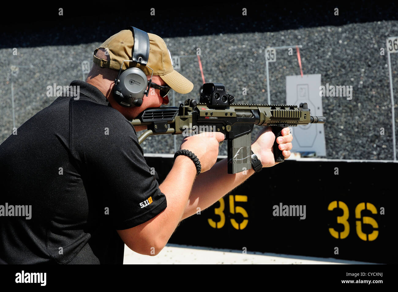 Gunman test firing automatic rifle at the FBI shooting range in Chicago ...