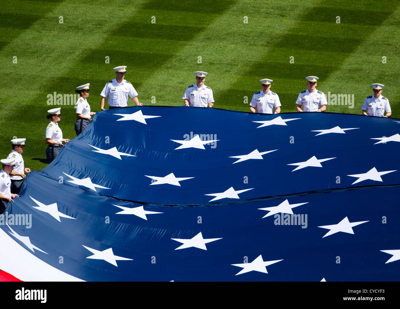 An American flag being held at a baseball game Stock Photo - Alamy