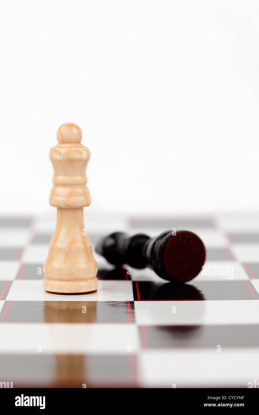 White queen standing with black queen lying Stock Photo - Alamy