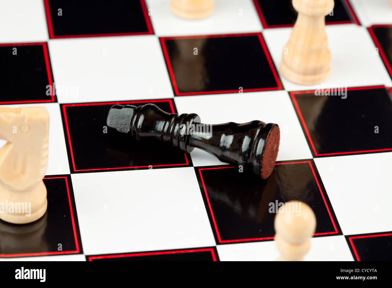 Black chessman lying Stock Photo - Alamy