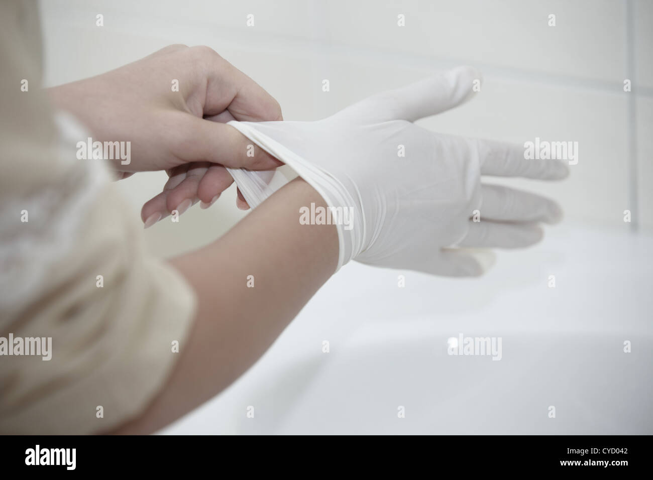 Hands of human taking on rubber gloves Stock Photo - Alamy