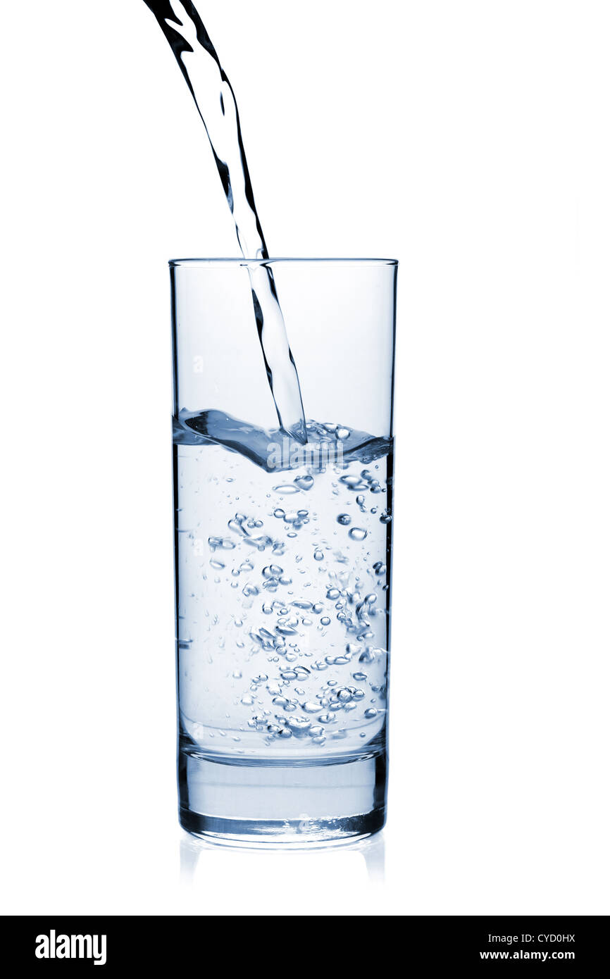 Water is poured into a glass. Isolated on white background Stock Photo ...