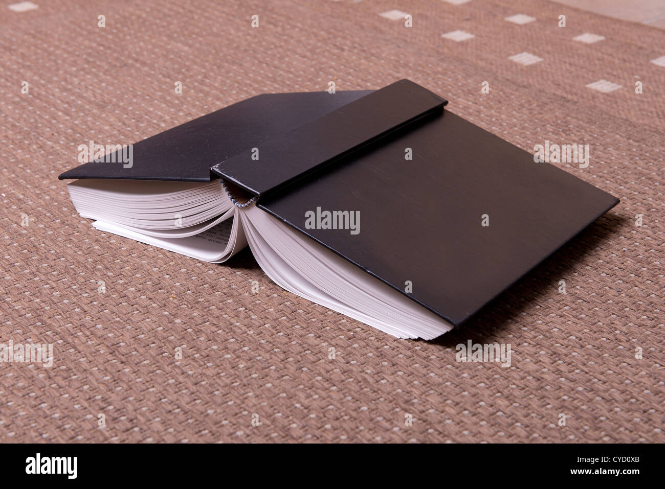 a book on the floor Stock Photo - Alamy