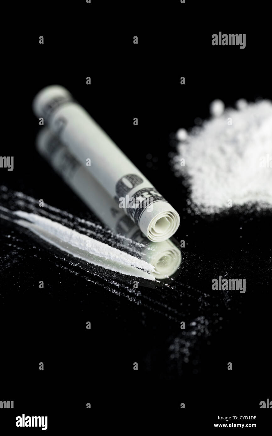 Rolled up note beside a line Stock Photo - Alamy