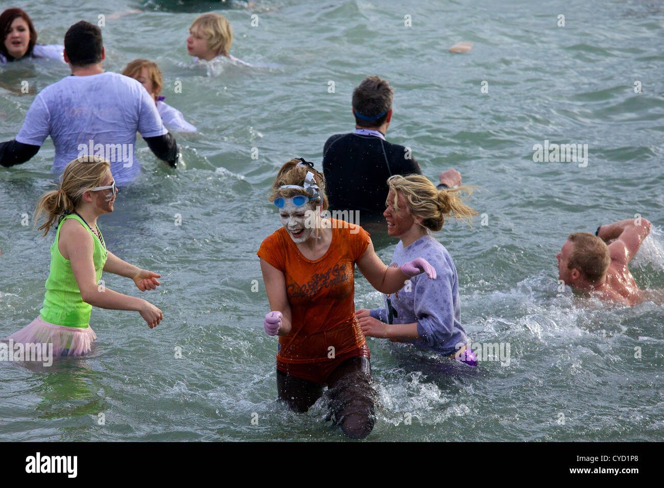 Fancy dress swimmers brave the icy sea during the annual West Bay ...