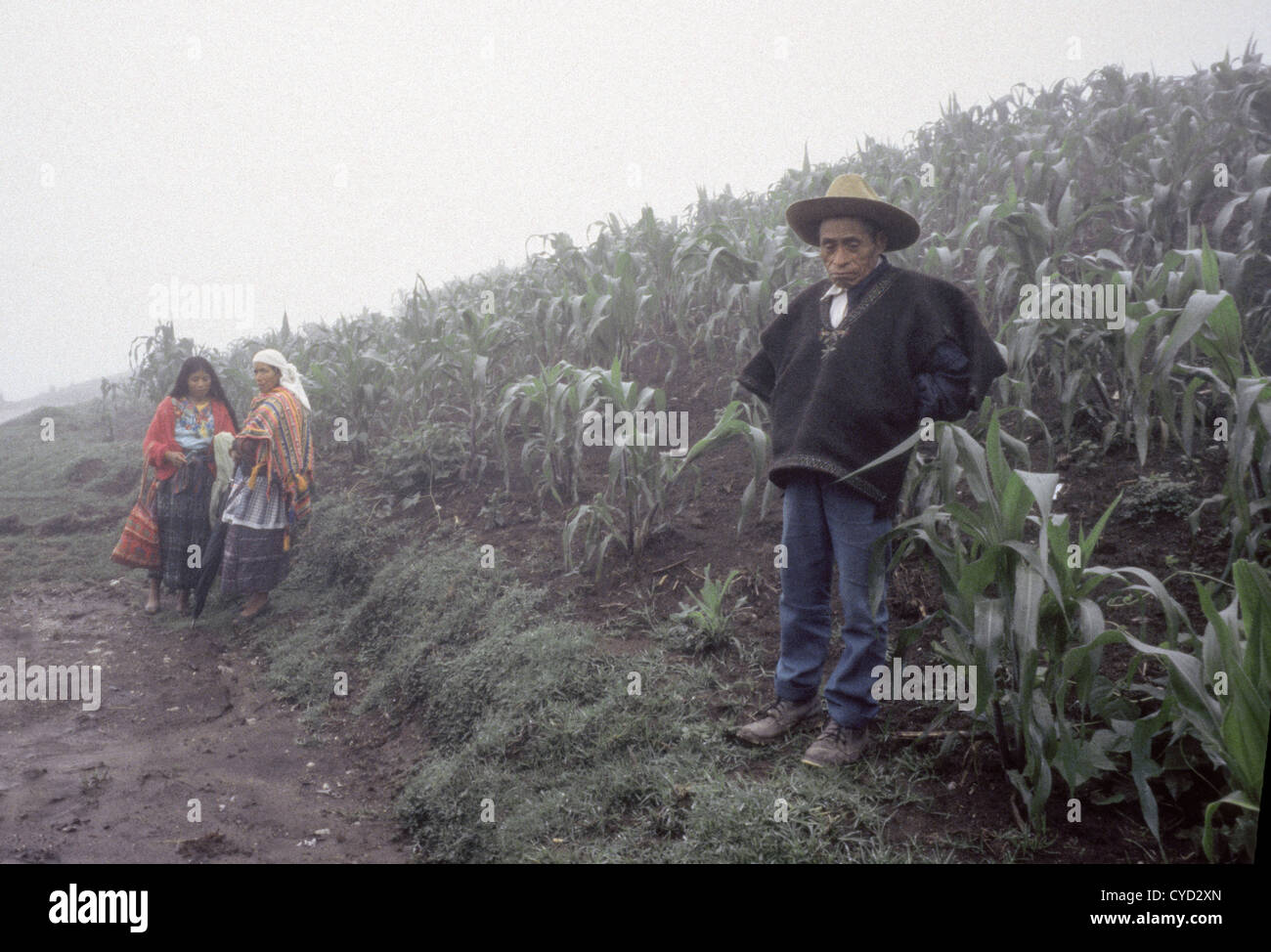 Guatemalan Mayan Quiche man and women in traditional dress wait in a ...