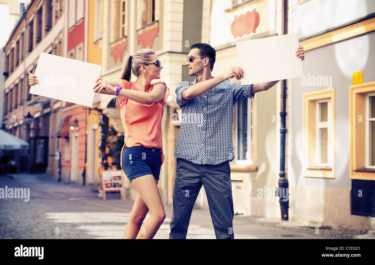 Cute couple with advertise Stock Photo - Alamy