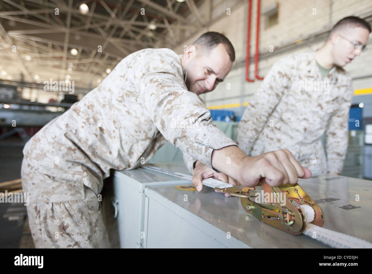 Gunnery Sgt. Walter K. Saucier prepares containers for transport with ...