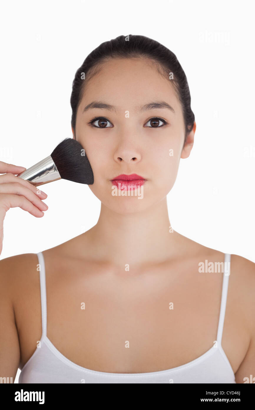 Woman using powder brush Stock Photo - Alamy
