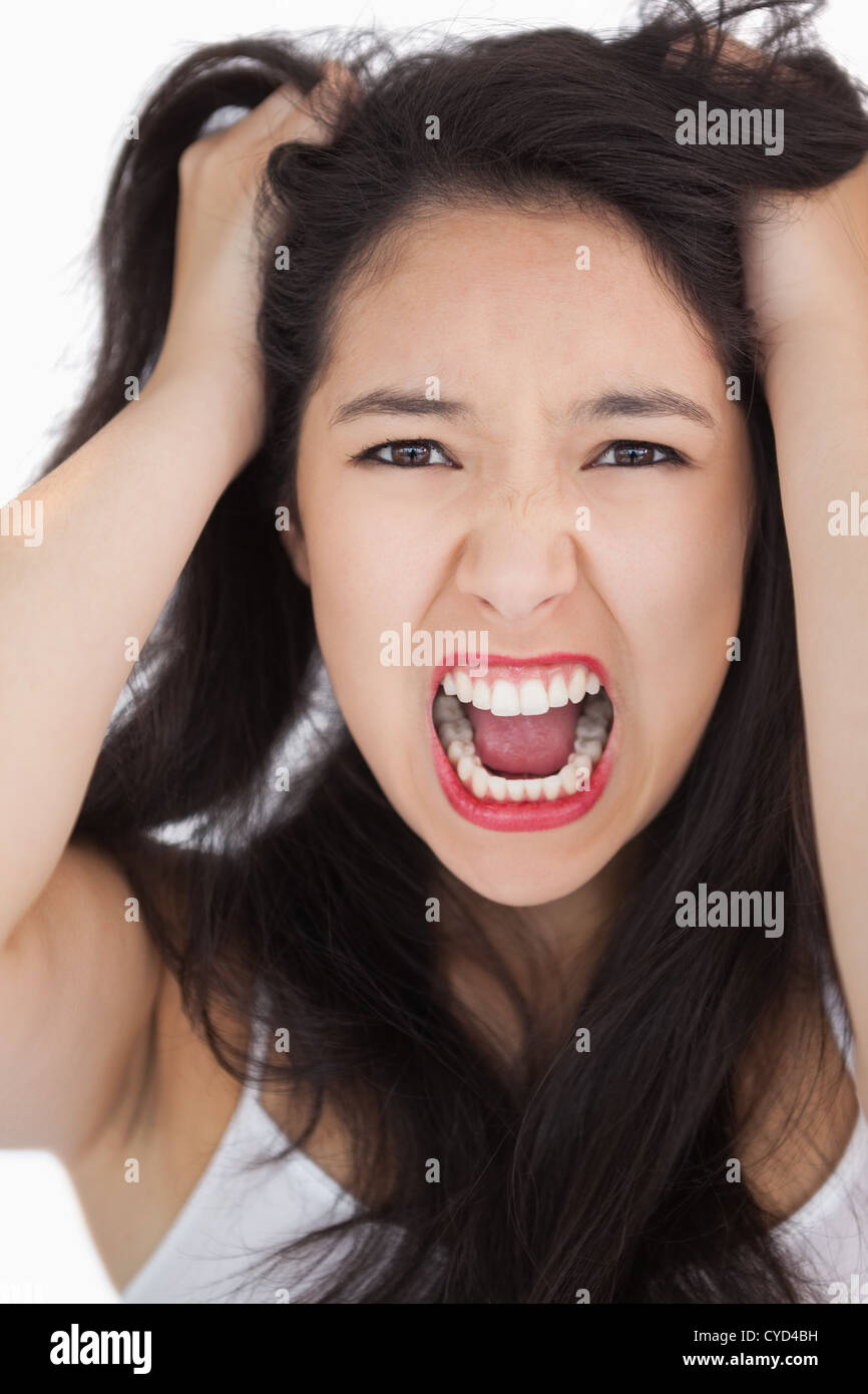 Woman screaming and pulling her hair out Stock Photo - Alamy