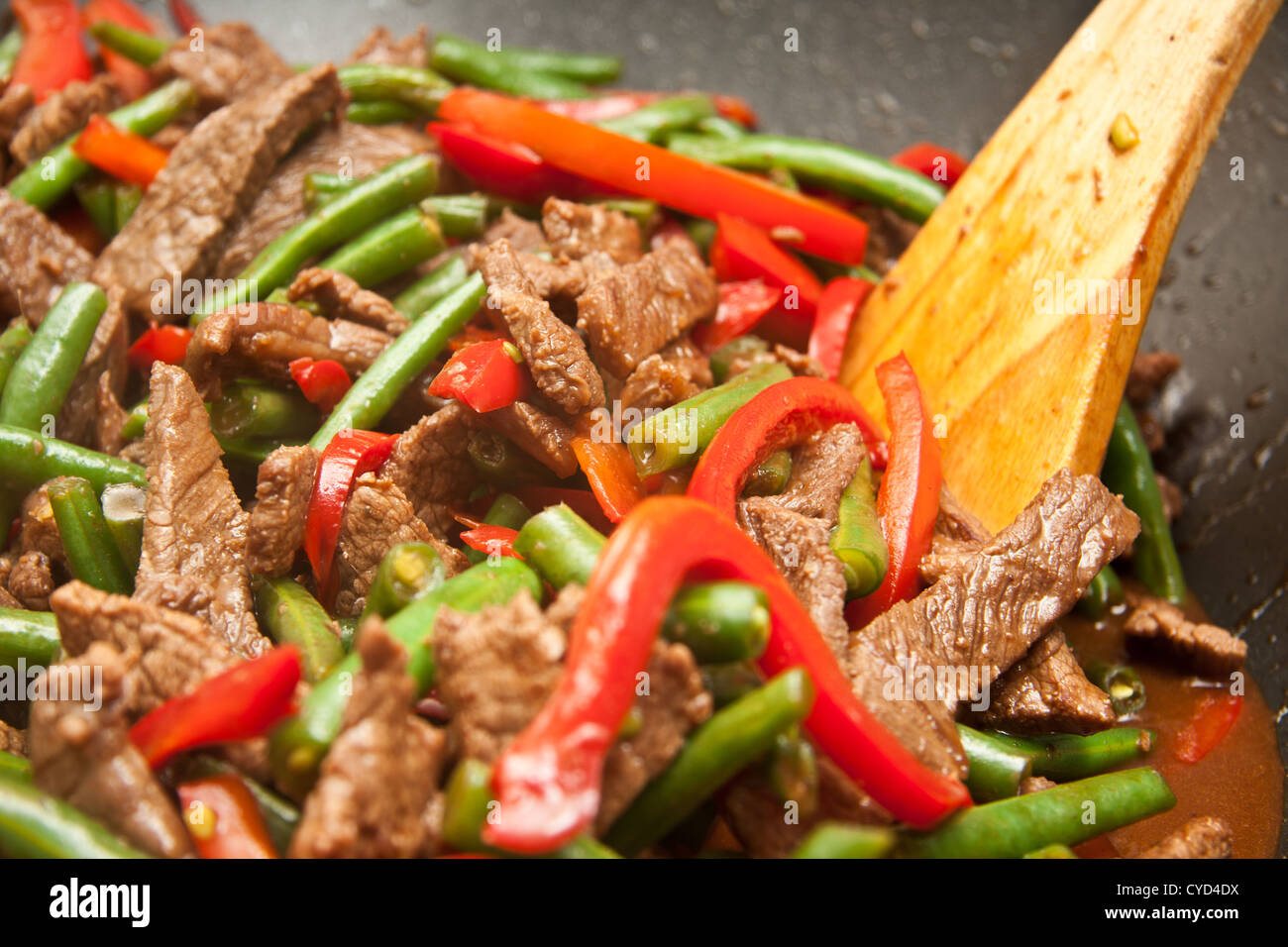 Cooking delicious beef, bean, capsicum stir-fry in a wok Stock Photo ...