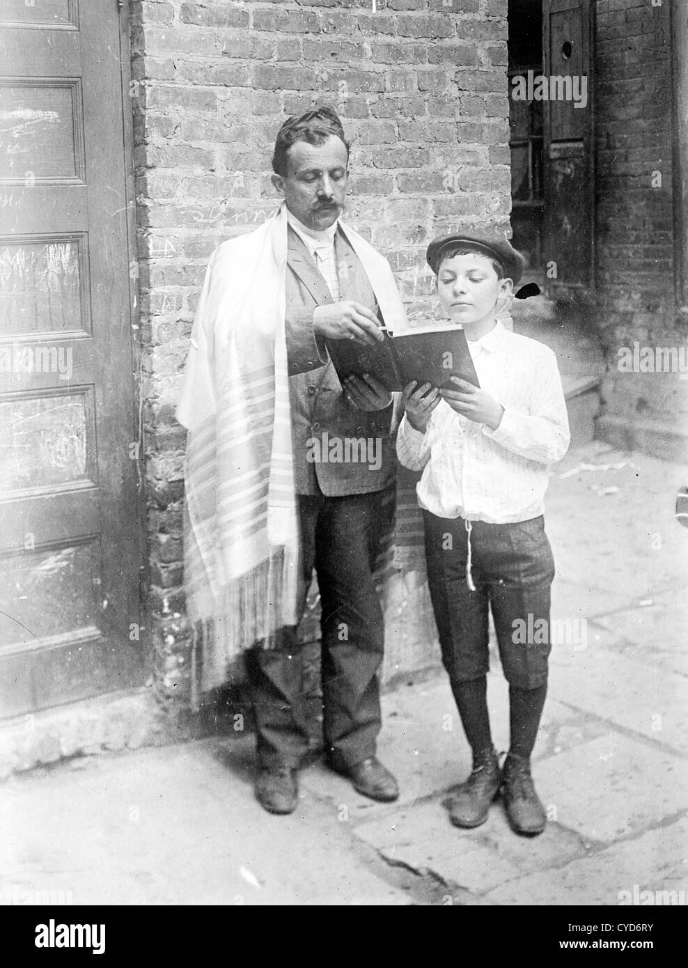 Man boy reading from bible on yom kippur historical archive Black and ...
