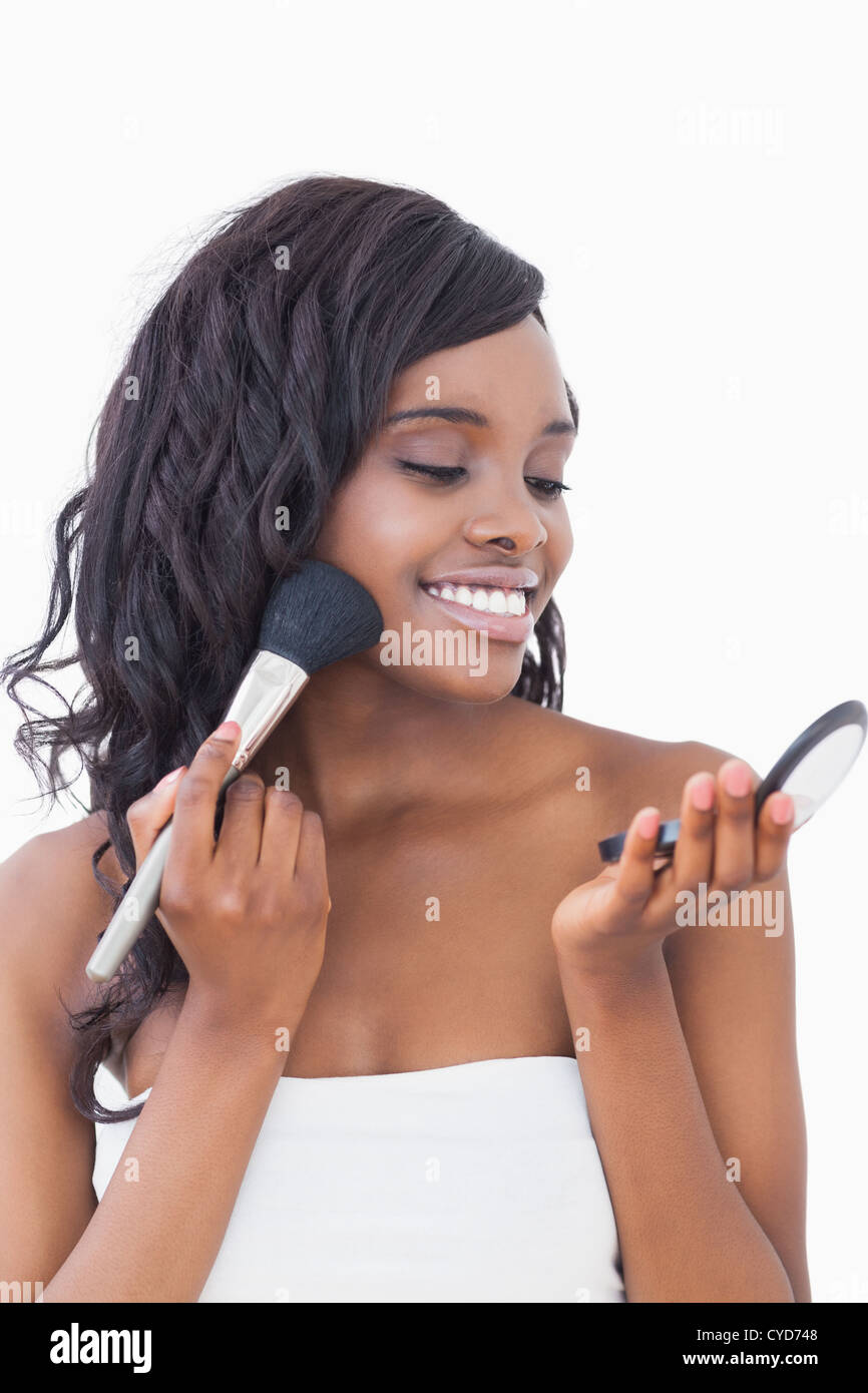 Woman putting on face powder Stock Photo - Alamy