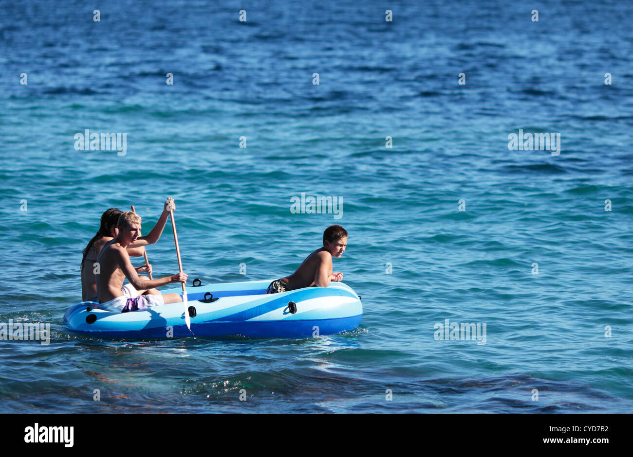 Young people in a dinghy in the Med Stock Photo - Alamy