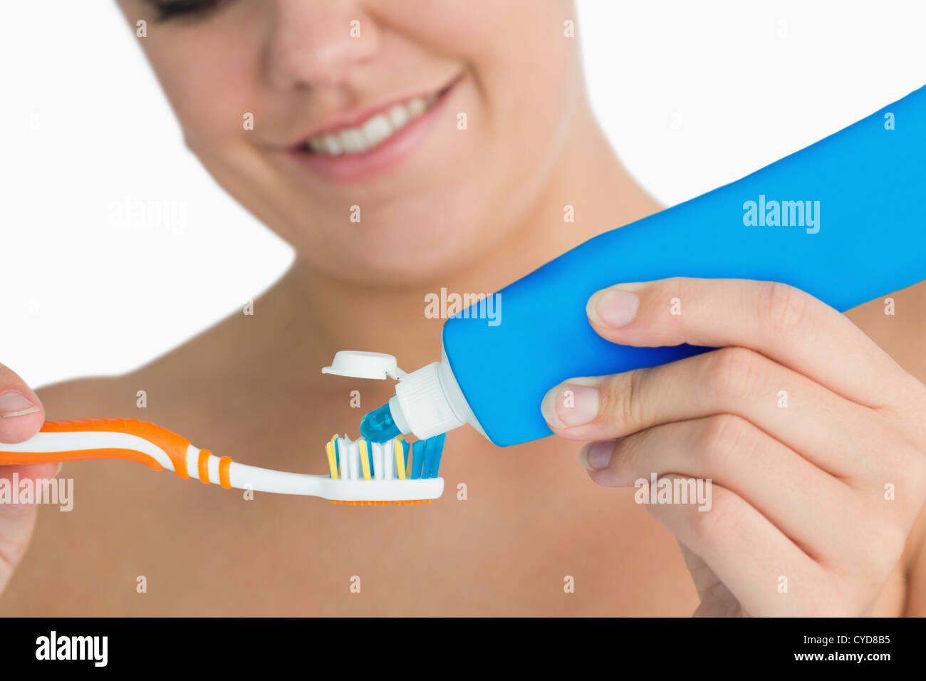 Woman putting toothpaste on toothbrush Stock Photo - Alamy