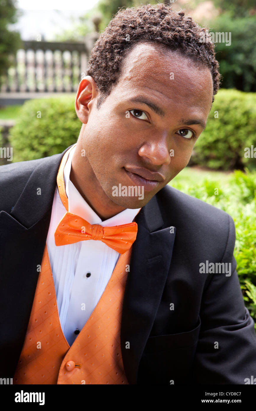 A man from a wedding party poses for a portrait. Could be groom, best ...