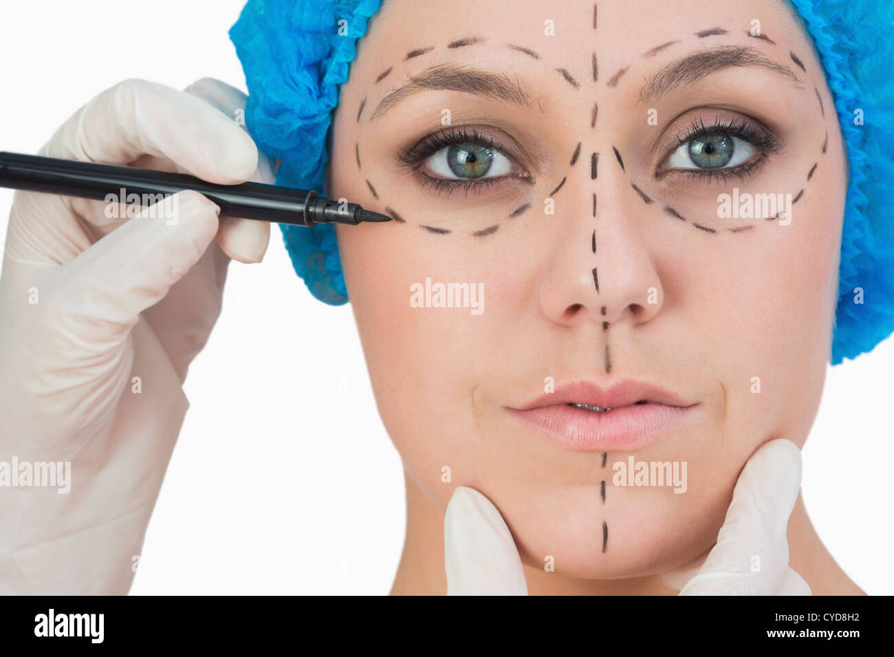 Plastic surgeon drawing on face Stock Photo - Alamy