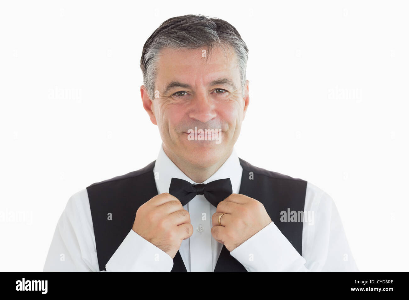 Waiter adjusting his own bow tie Stock Photo - Alamy