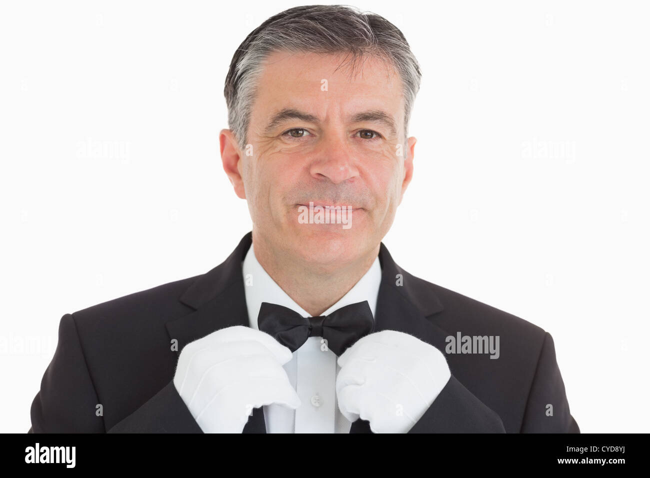 Smiling waiter adjusting his bow tie Stock Photo - Alamy