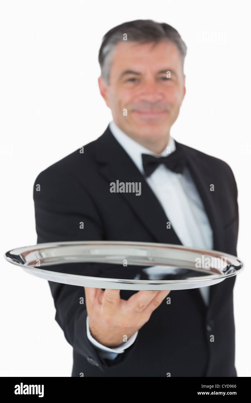 Cheerful waiter holding a silver tray Stock Photo - Alamy