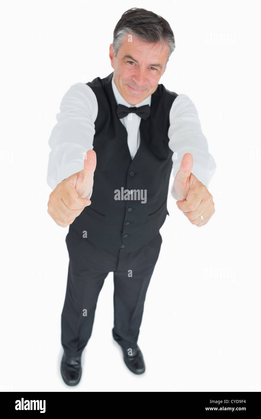 Smiling waiter with thumbs up Stock Photo - Alamy