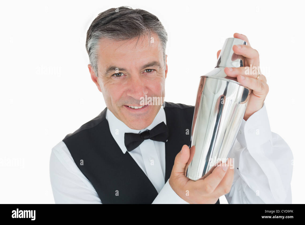 Smiling waiter shaking drink in cocktail shaker Stock Photo - Alamy