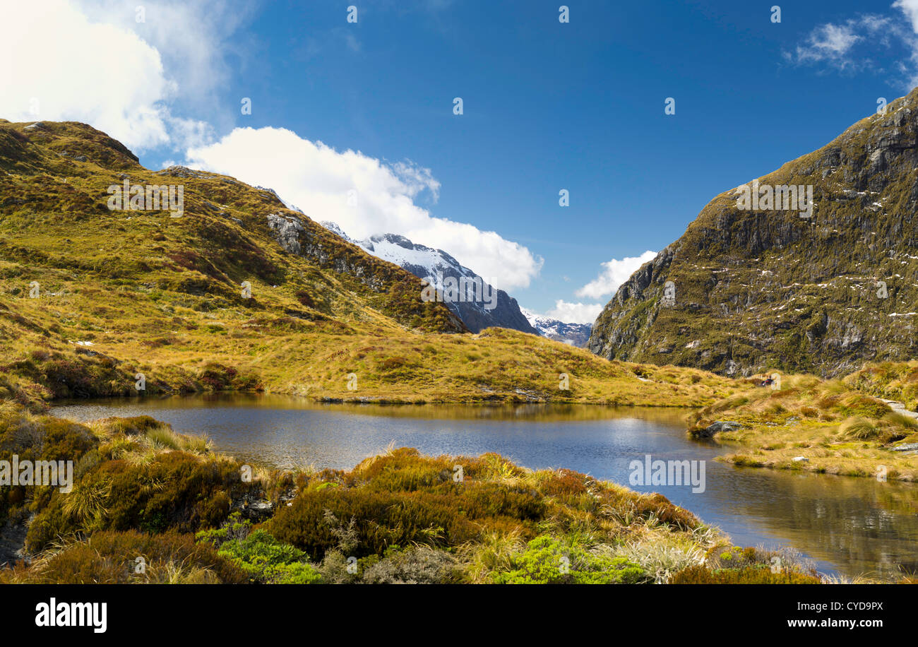 Tarn and clouds at MacKinnon Pass, Milford Track, Fiordland National ...