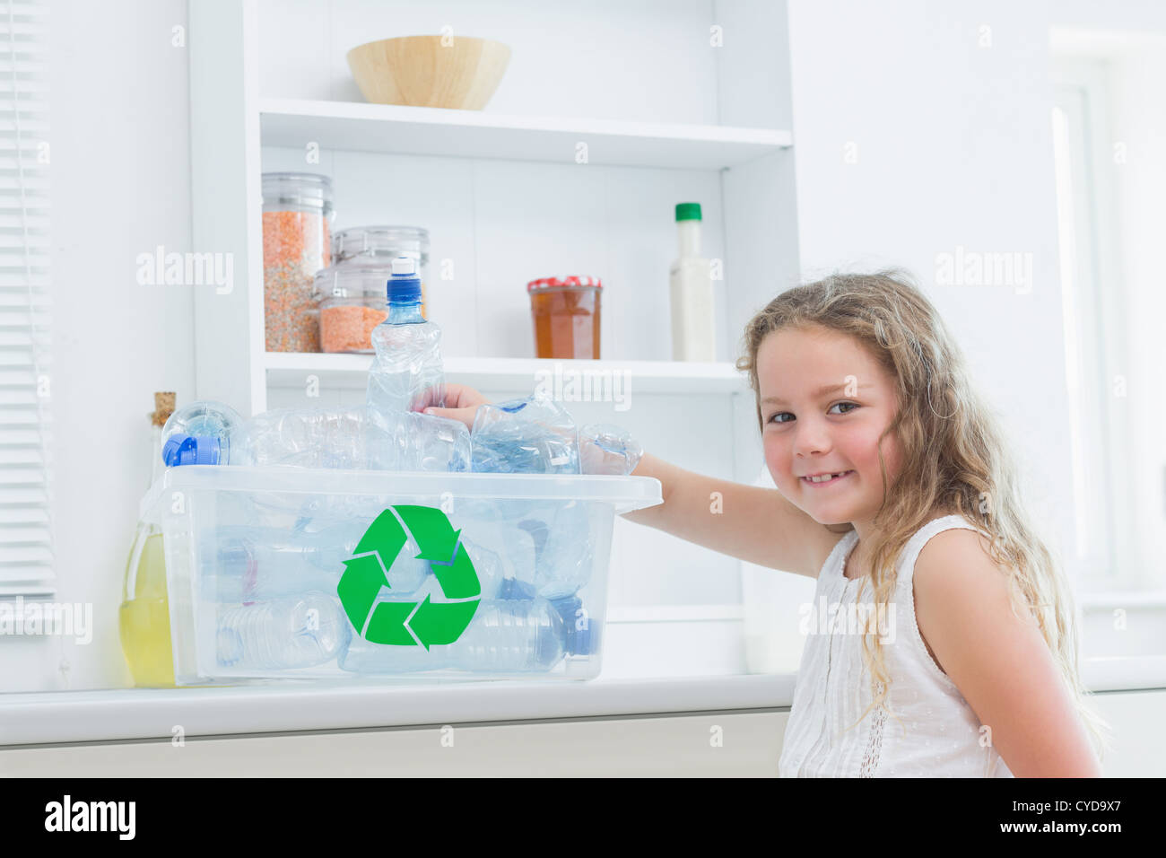 Girl sorting plastics into crates Stock Photo - Alamy