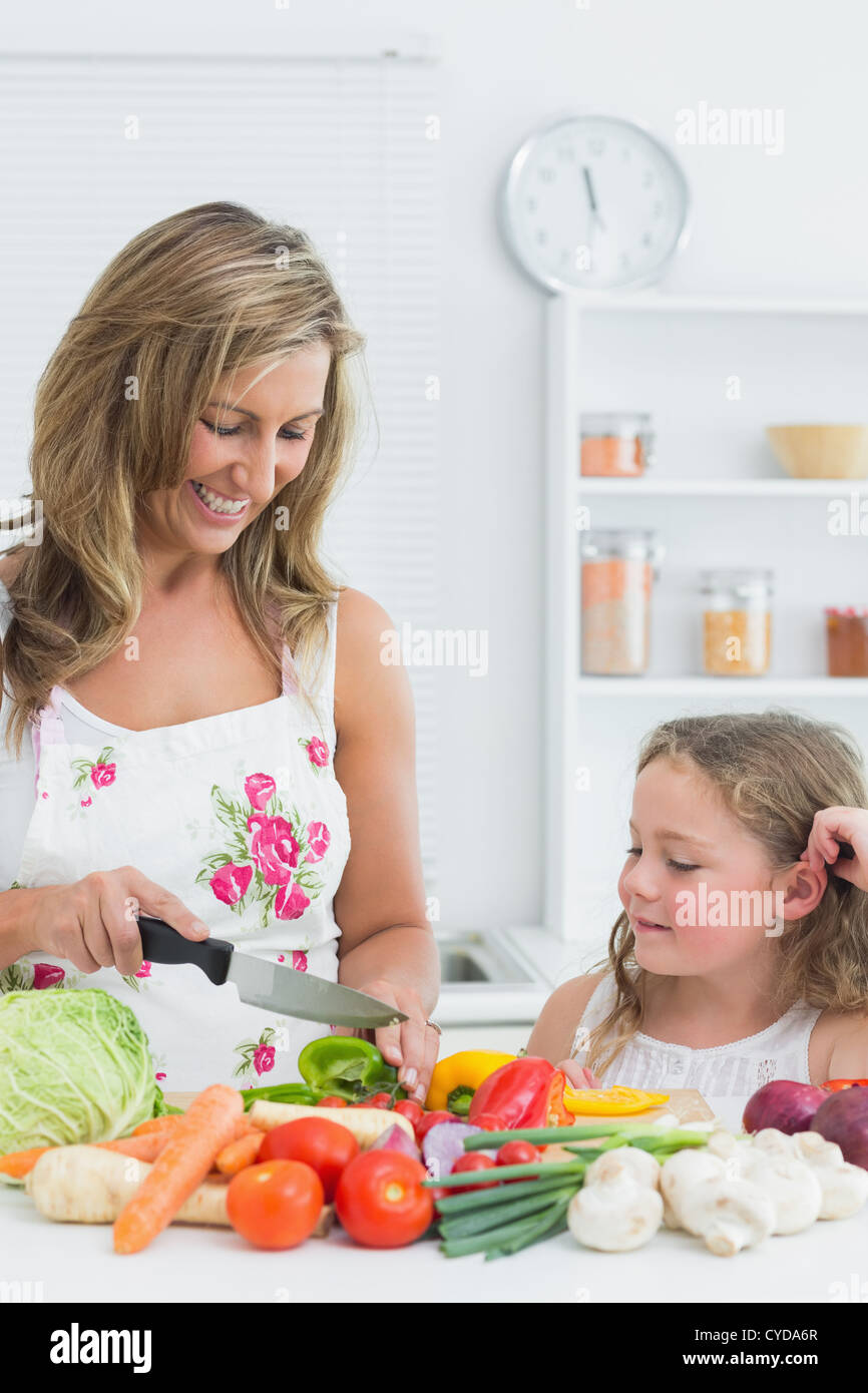 Mother preparing vegetable on the table in the kitchen Stock Photo - Alamy