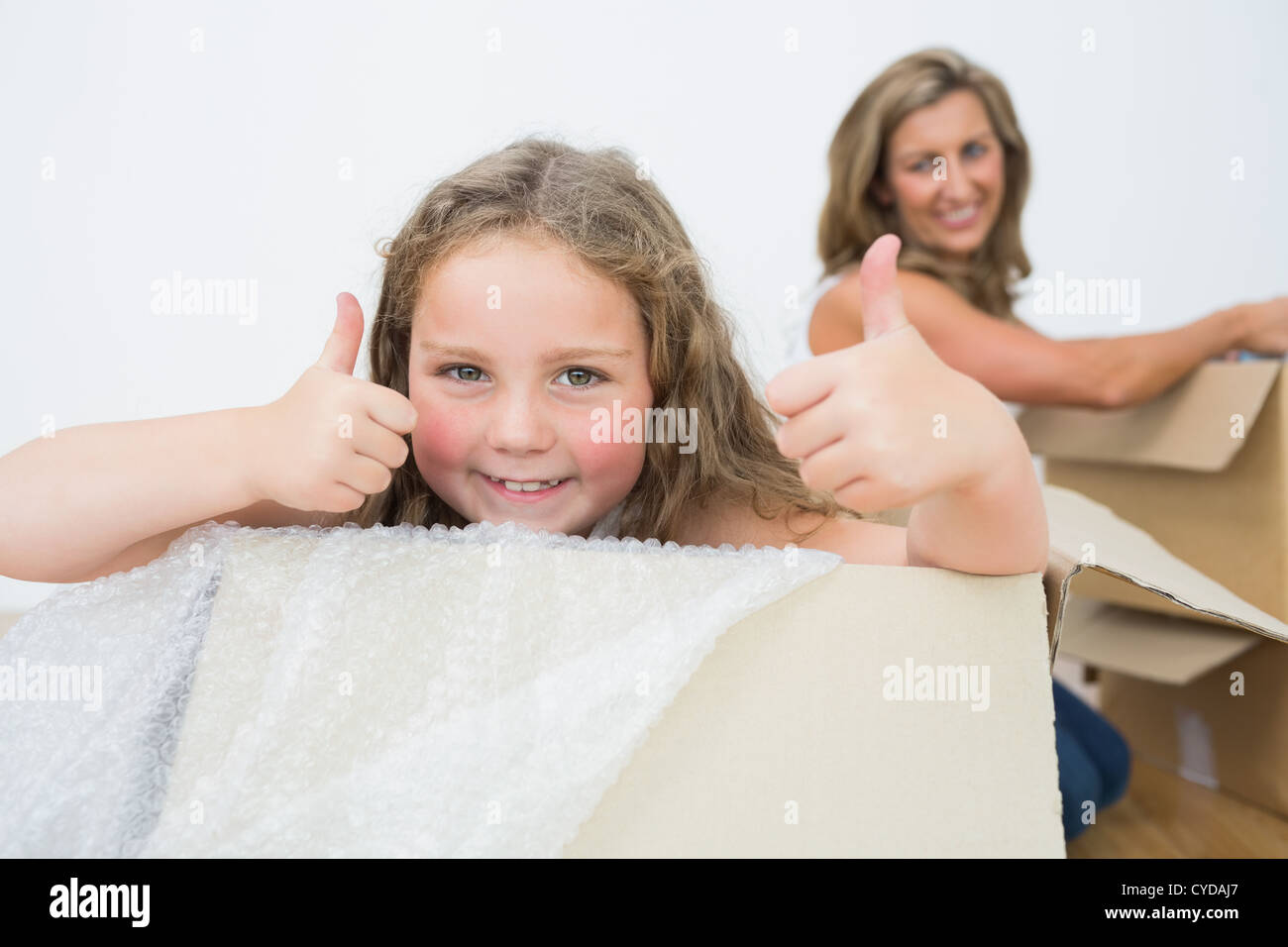 Daughter in box showing thumbs up Stock Photo - Alamy