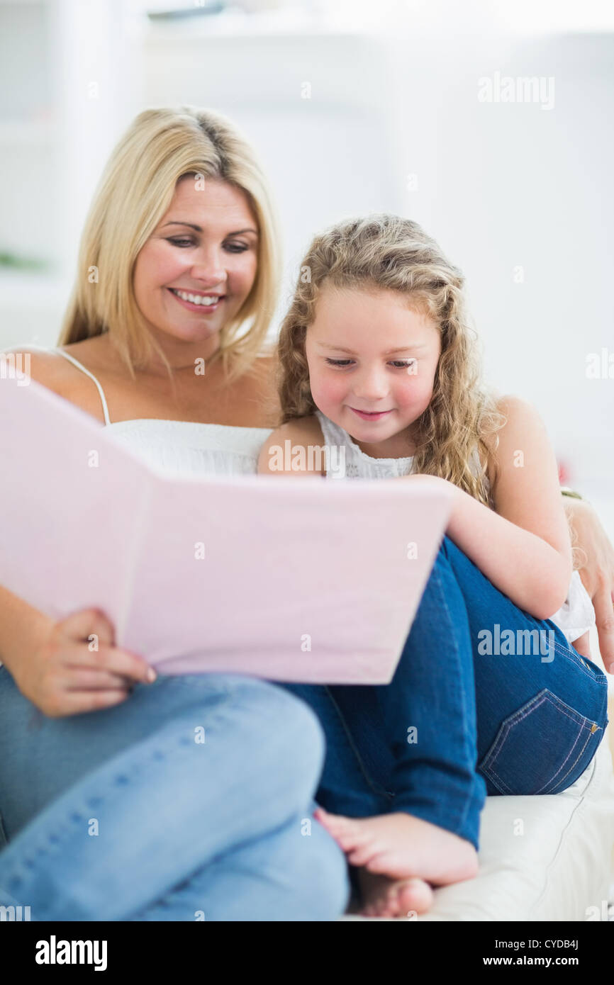Mother sitting on the sofa with her daughter Stock Photo - Alamy