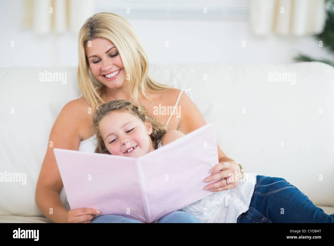Daughter and mother resting on the sofa Stock Photo - Alamy