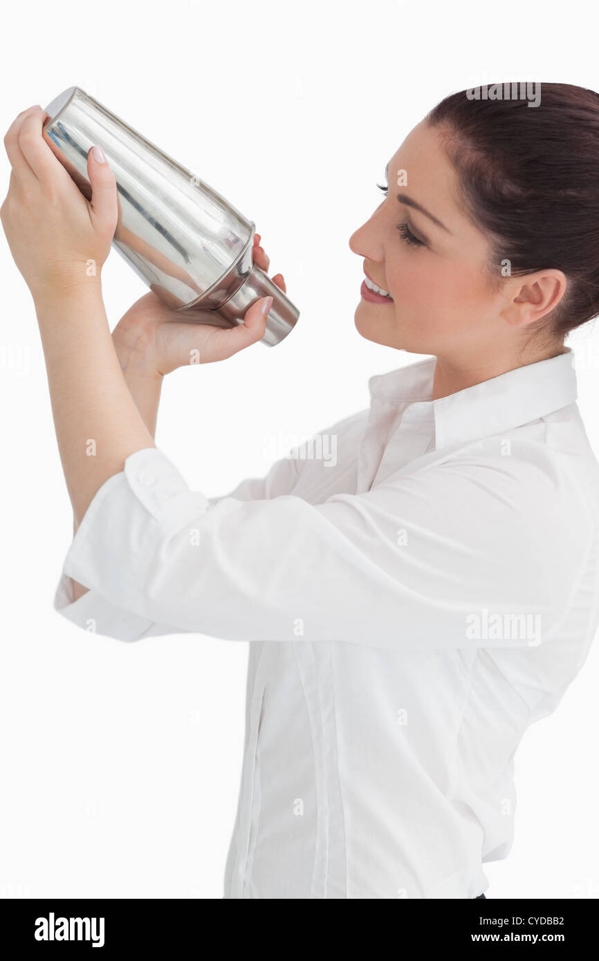 Woman using cocktail shaker while looking at it Stock Photo - Alamy